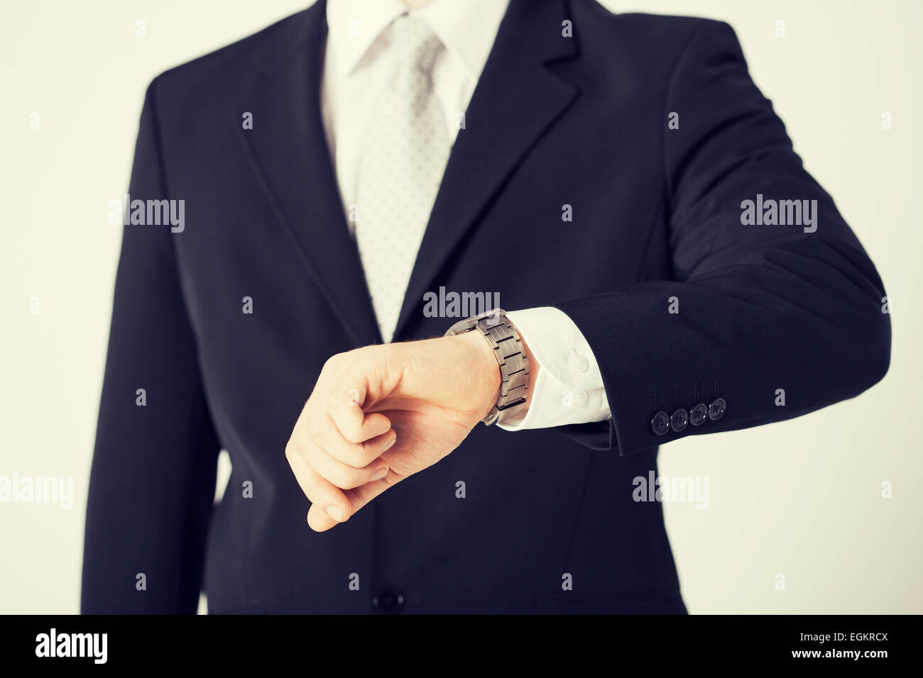 man looking at wristwatch Stock Photo - Alamy