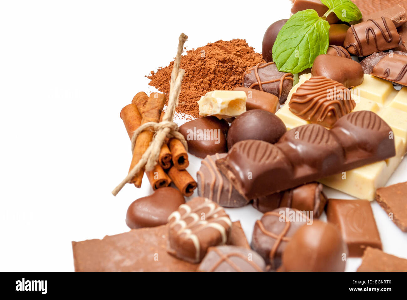 Many chocolate and cinnamon isolated on white background Stock Photo ...