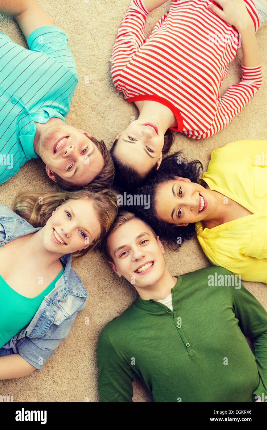 group of smiling people lying down on floor Stock Photo - Alamy