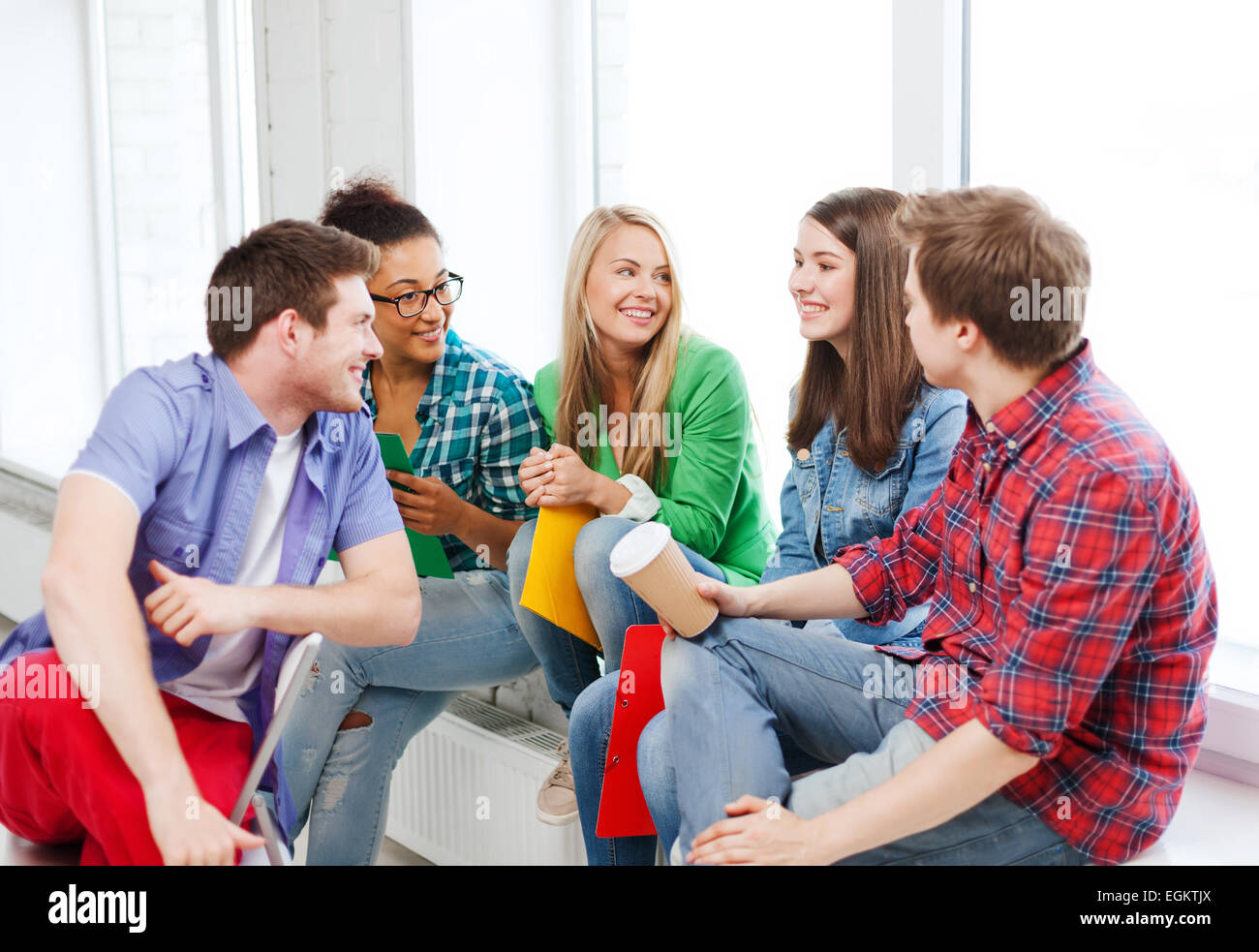 students communicating and laughing at school Stock Photo - Alamy