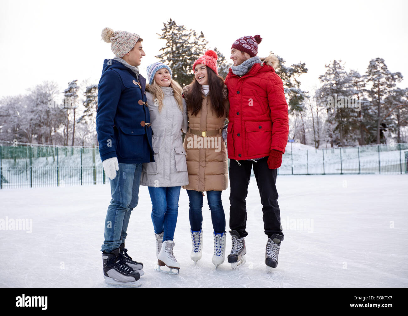 happy friends ice skating on rink outdoors Stock Photo - Alamy