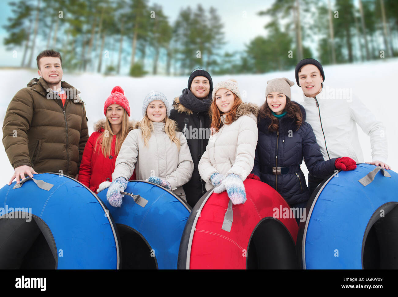 group of smiling friends with snow tubes Stock Photo - Alamy