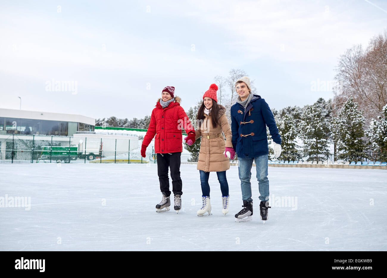 happy friends ice skating on rink outdoors Stock Photo - Alamy