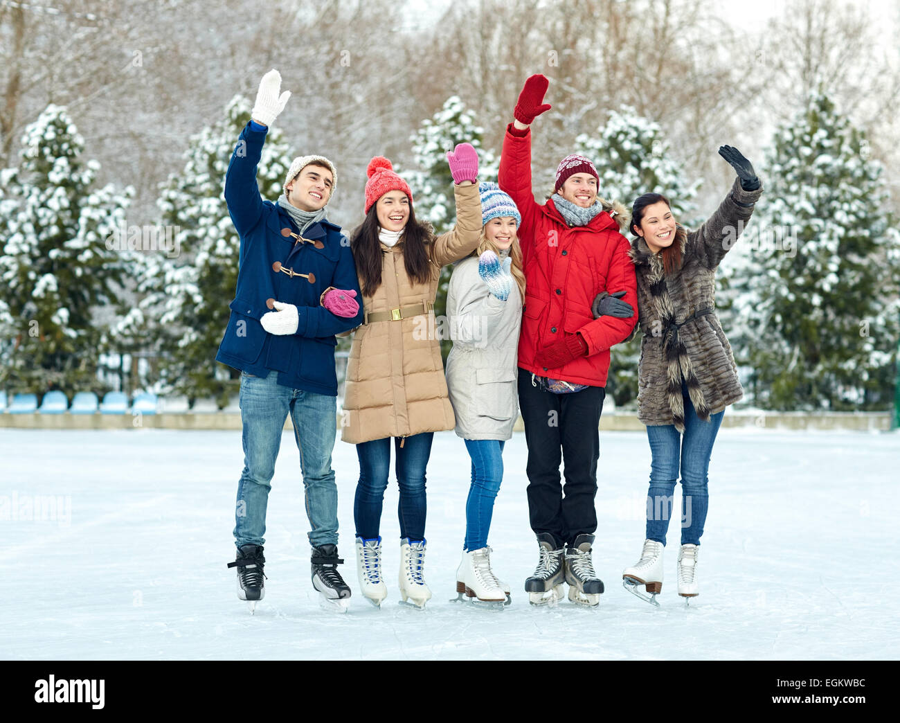 happy friends ice skating on rink outdoors Stock Photo - Alamy