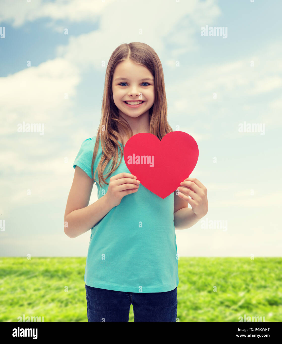 smiling little girl with red heart Stock Photo - Alamy