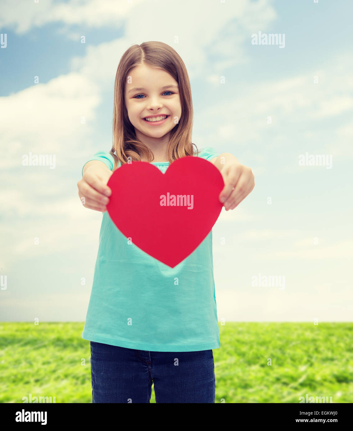 smiling little girl giving red heart Stock Photo - Alamy