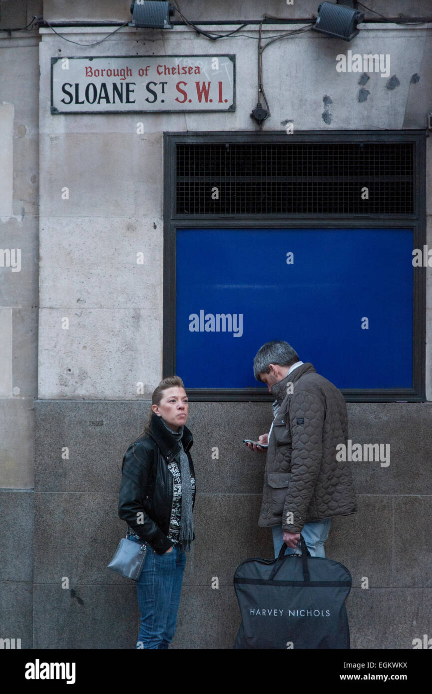 Two people standing on Sloane Street in Knightsbridge following a ...