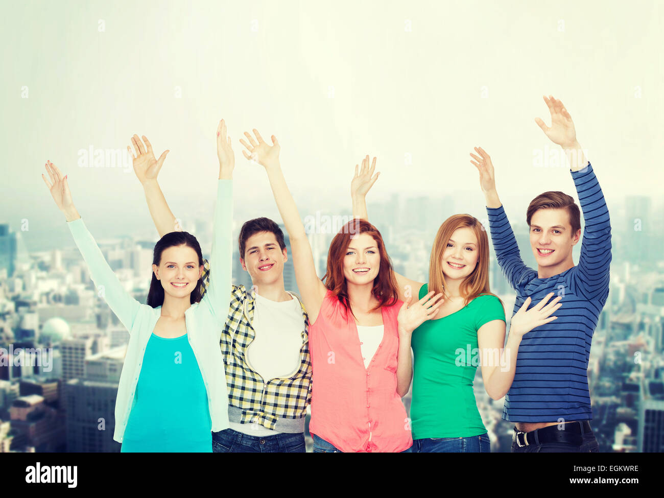 group of smiling students waving hands Stock Photo - Alamy