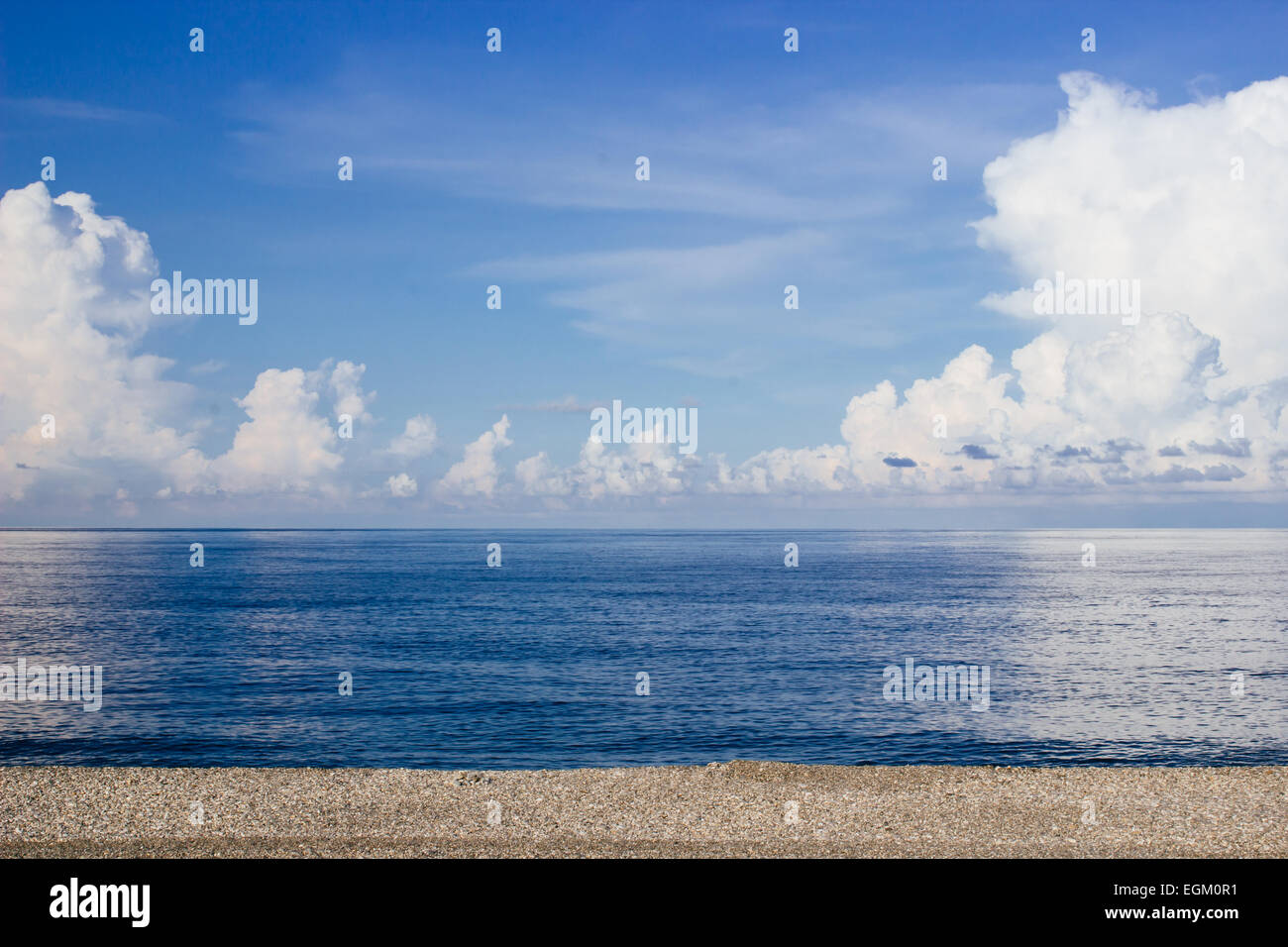 tropical sea ocean blue sky fluffy cumulus clouds Stock Photo - Alamy