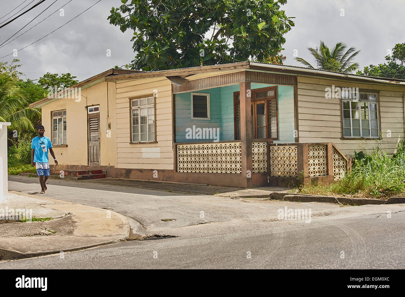 Barbados street view, wooden house, man walking towards camera Stock ...
