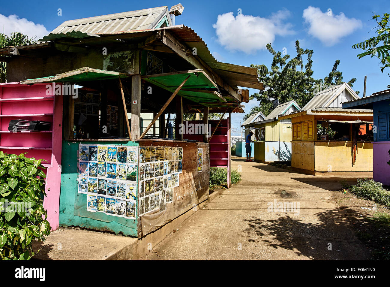 Wooden shacks serving as shops and vending stalls. Male figure in ...