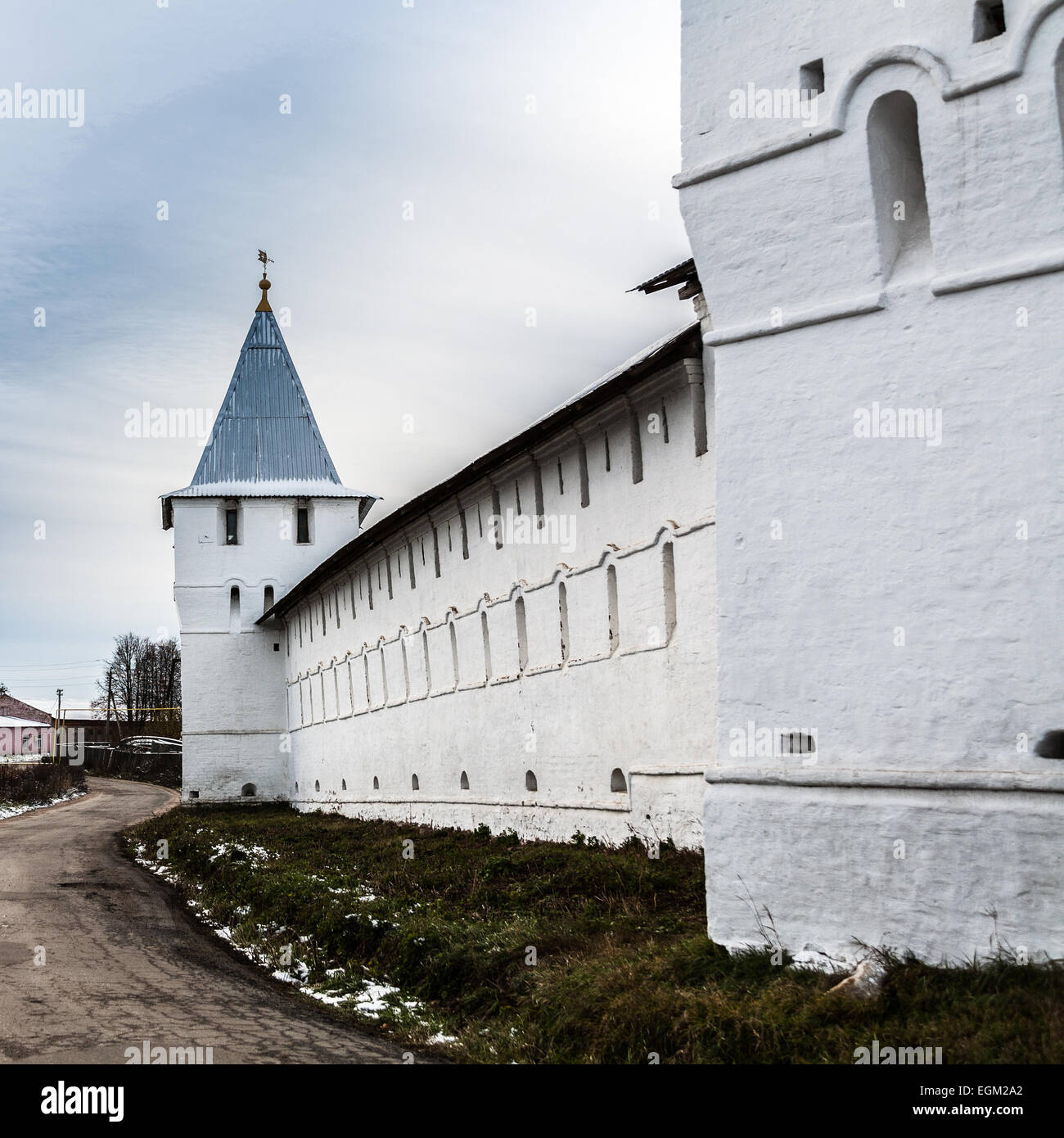 towers and walls of the medieval monastery of white stone with windows ...