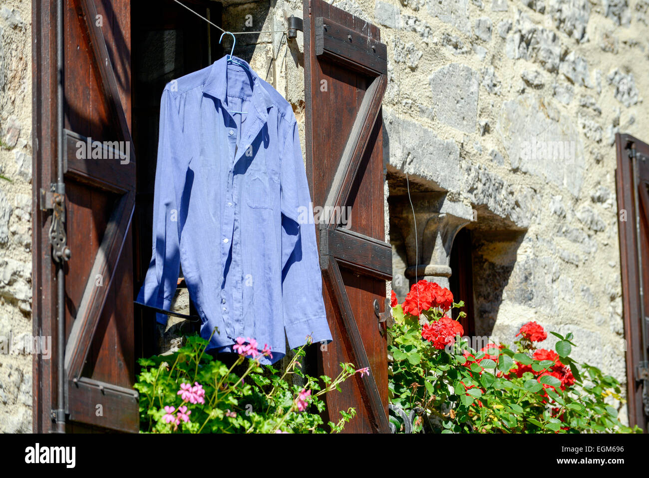 Blue men shirt hang up outside to dry france europe Stock Photo - Alamy