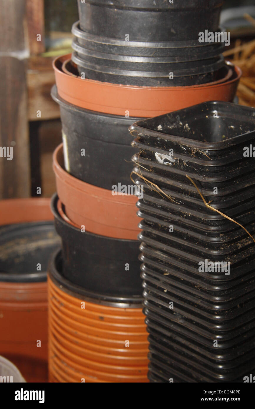 stacks of plastic plant pots in garden shed Stock Photo - Alamy