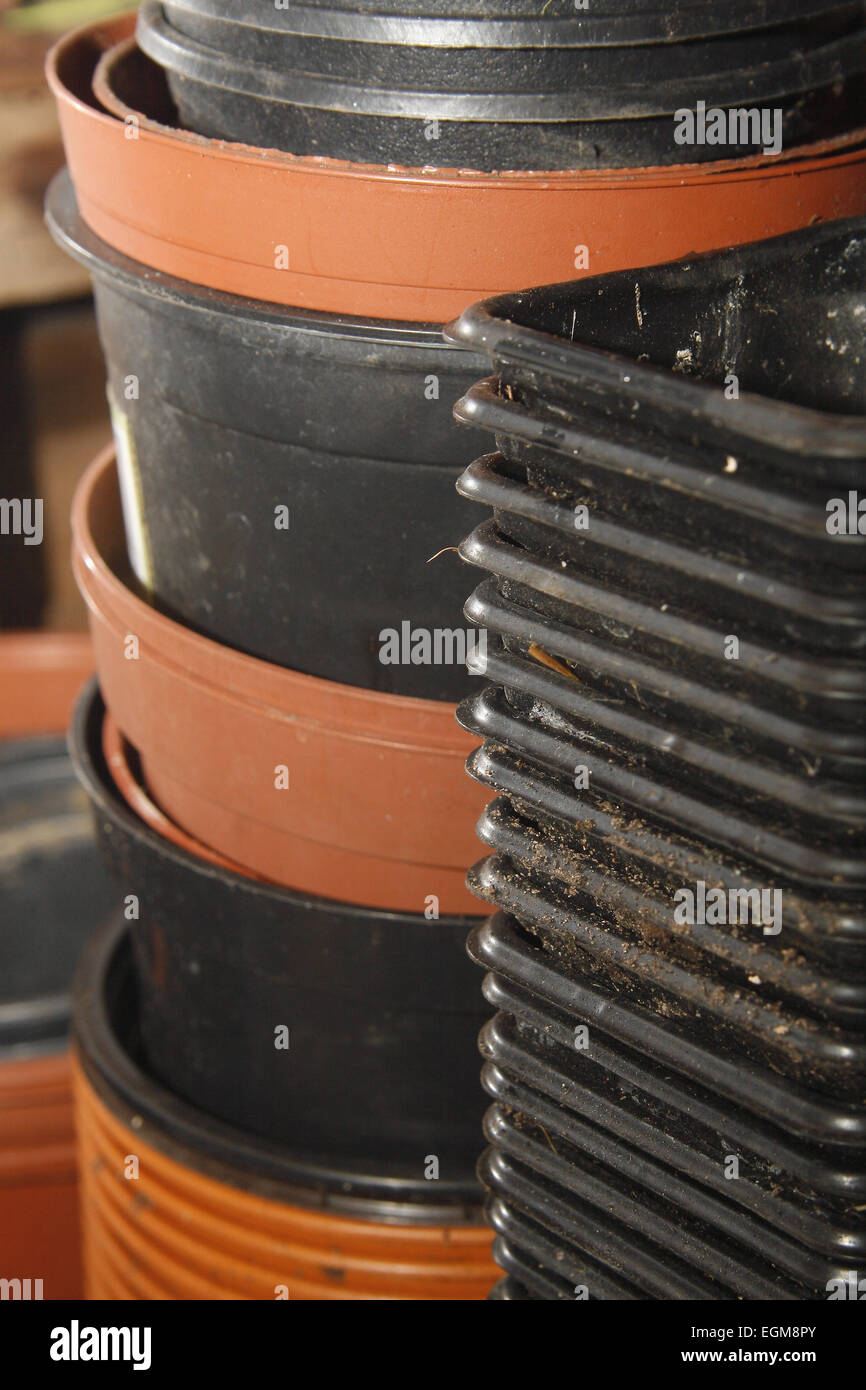 stacks of plastic plant pots in garden shed Stock Photo - Alamy