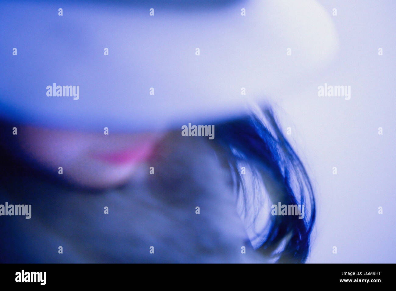 Blurred Blue Girl Wearing Hat Stock Photo - Alamy
