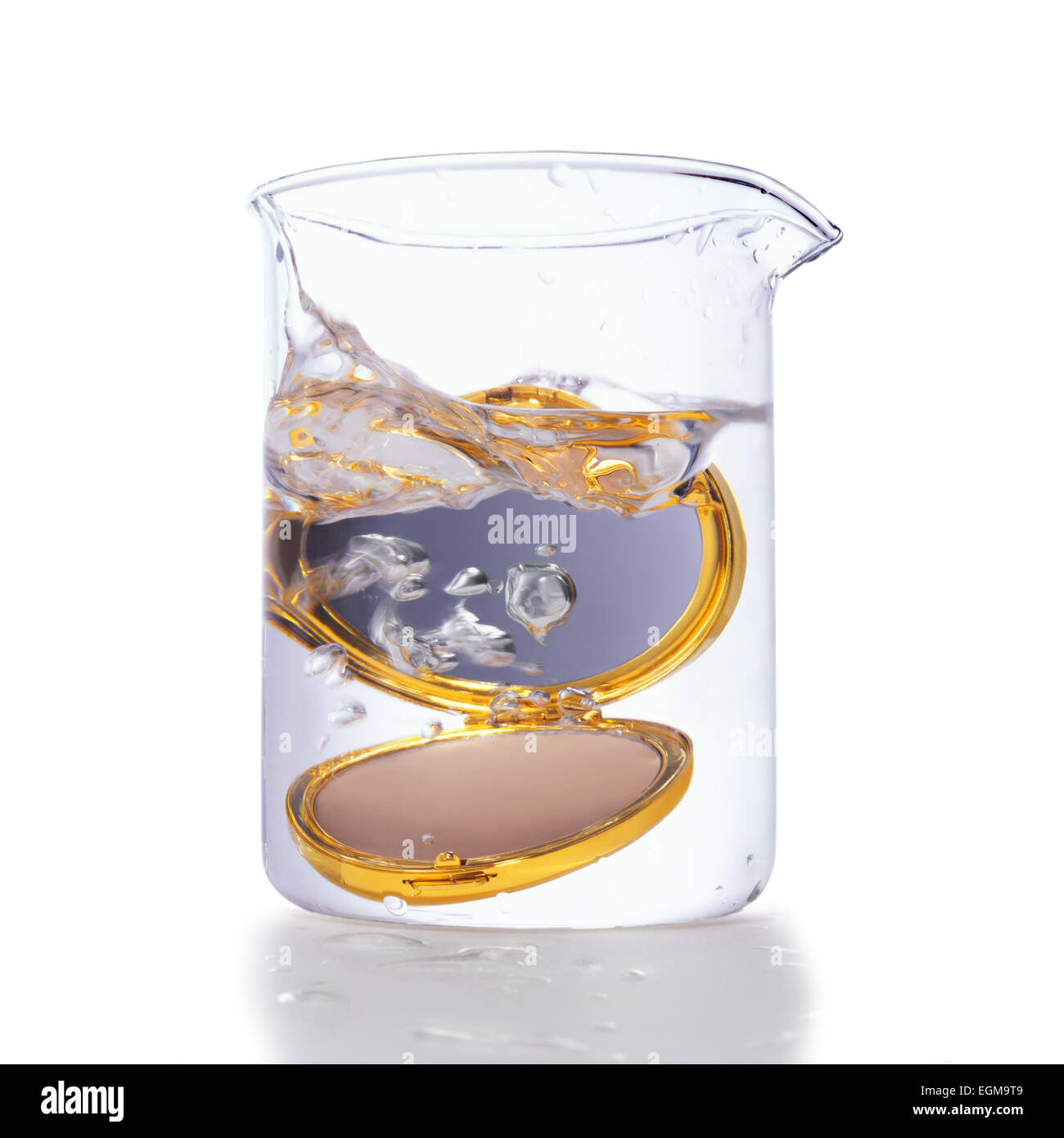 Gold Compact in Beaker of Water Stock Photo - Alamy