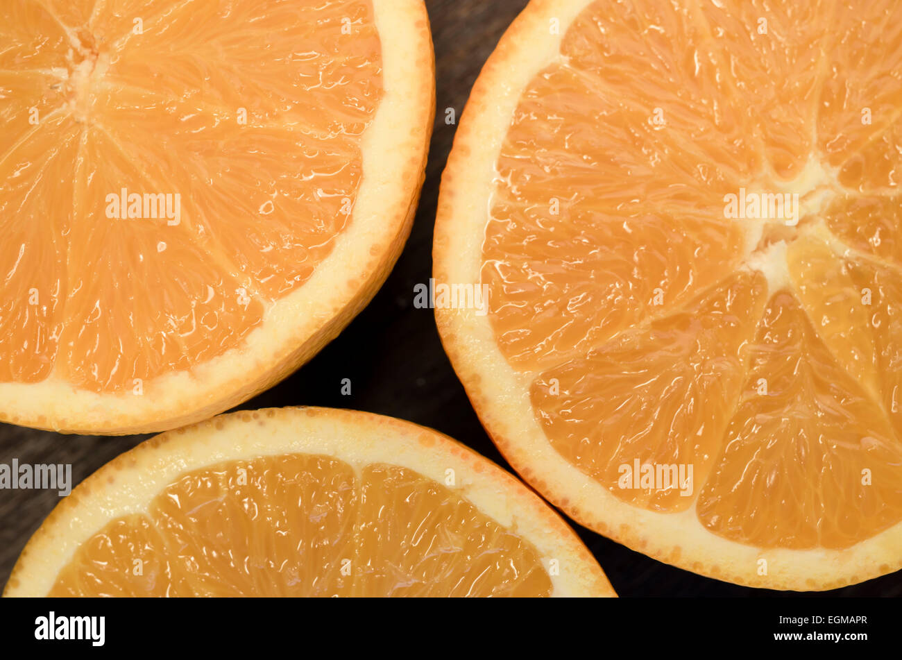 fresh ripe cutted oranges on a wood background Stock Photo - Alamy
