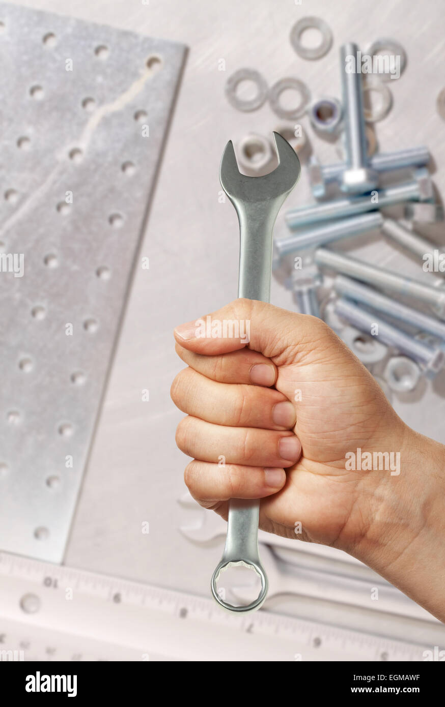 Hand holding spanner Stock Photo - Alamy