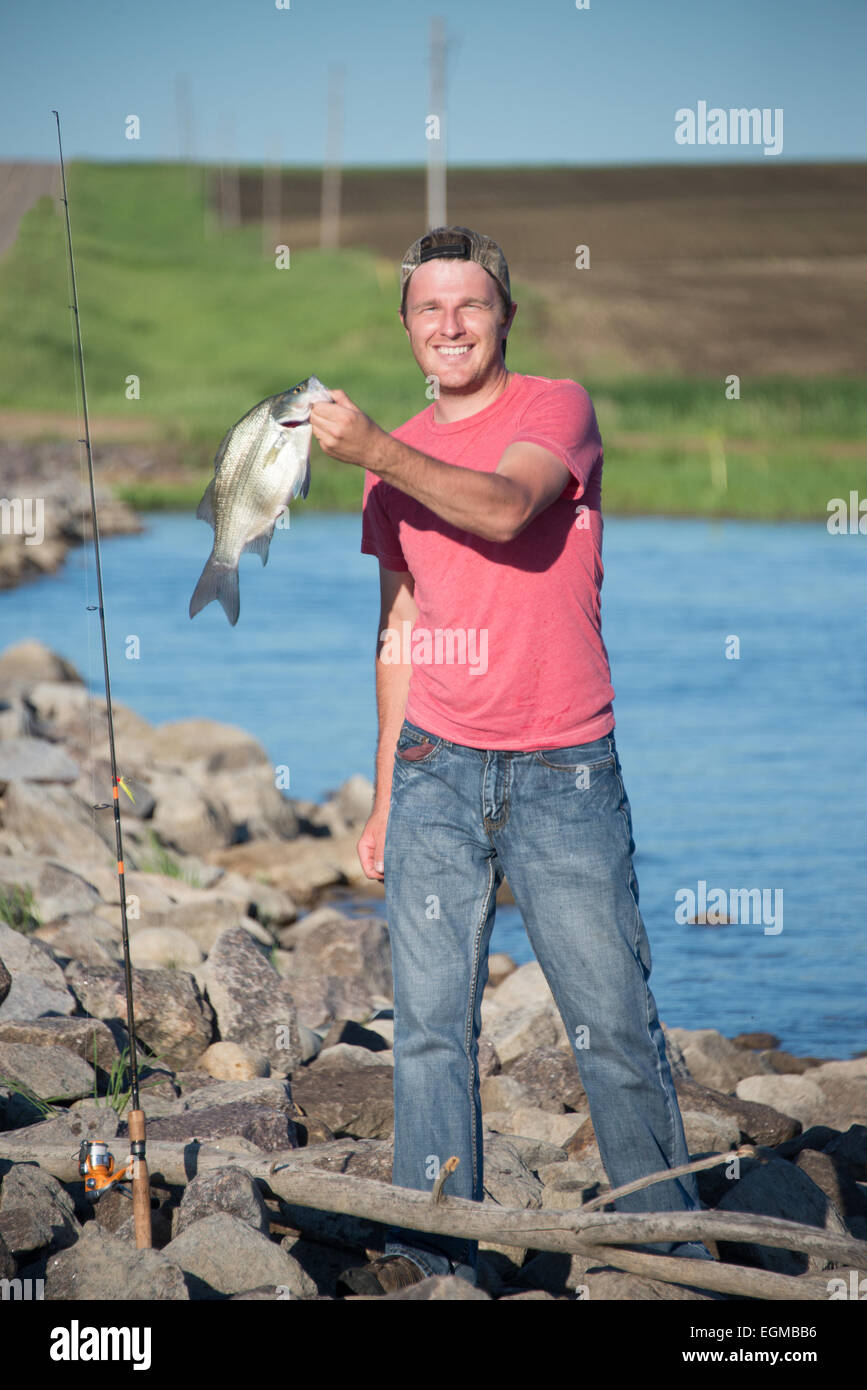 man catches a fish Stock Photo - Alamy