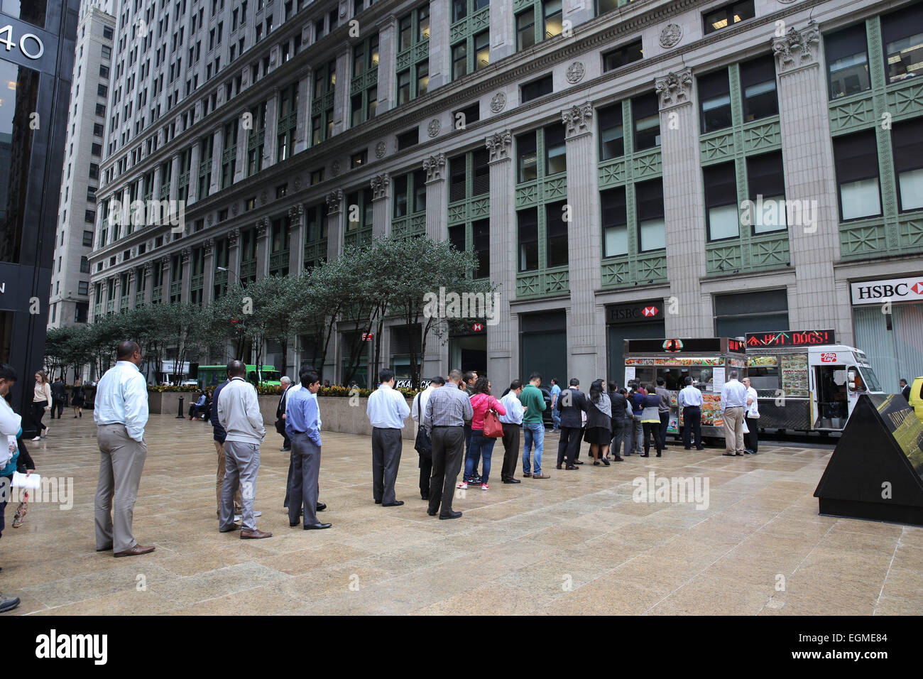 A line of lunch time customers at a mobile street vendor selling food ...