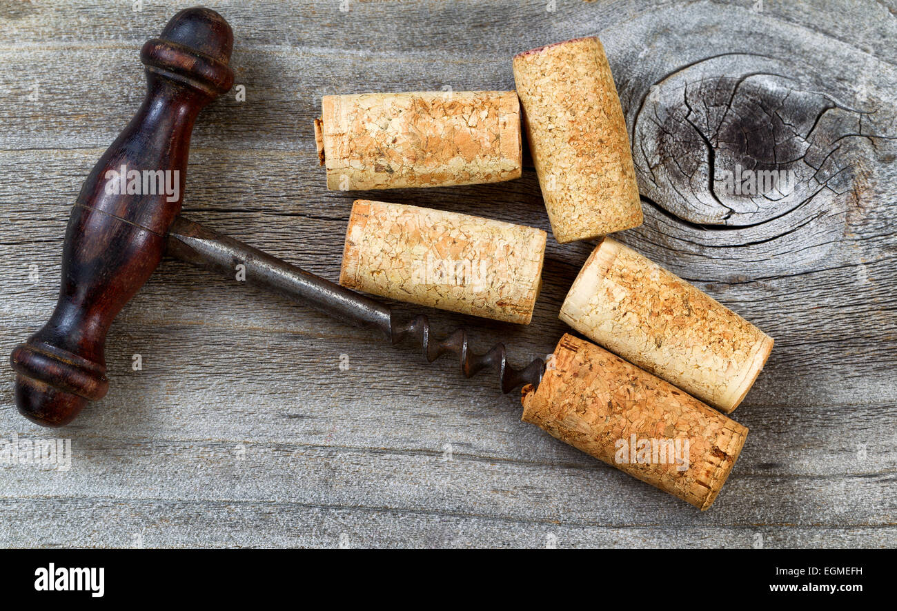 Top view angled shot of vintage corkscrew with five used corks on ...