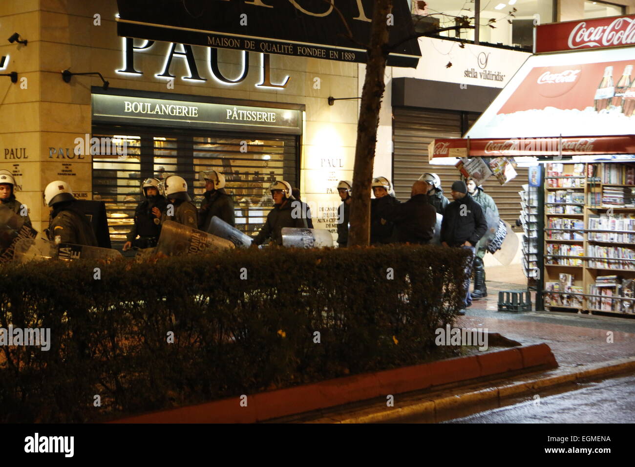 Police officers in riot gear follow the protest march without ...