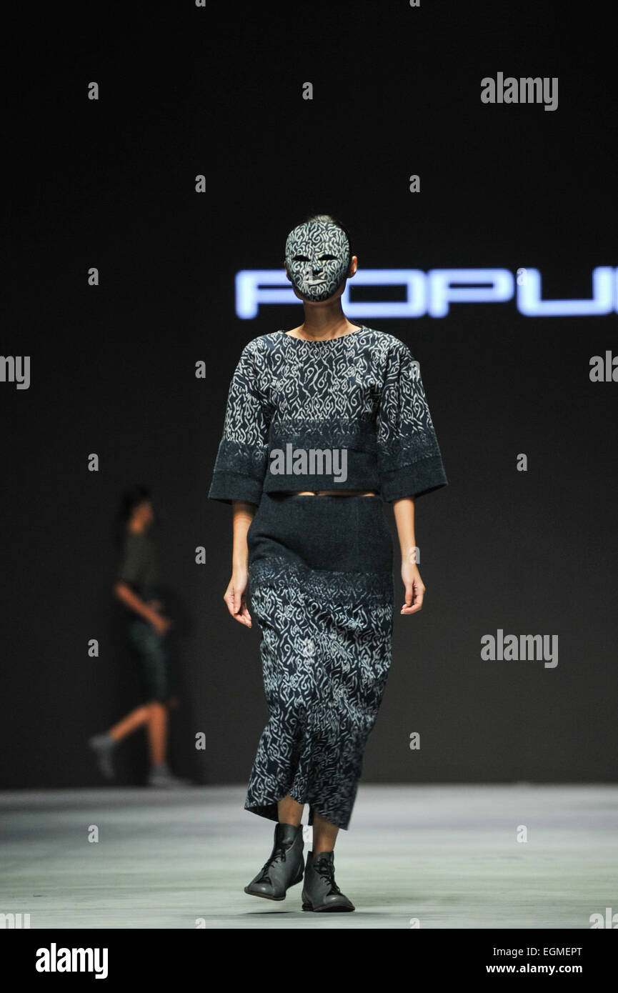 Jakarta, Indonesia. 26th Feb, 2015. A model wearing a mask presents a ...