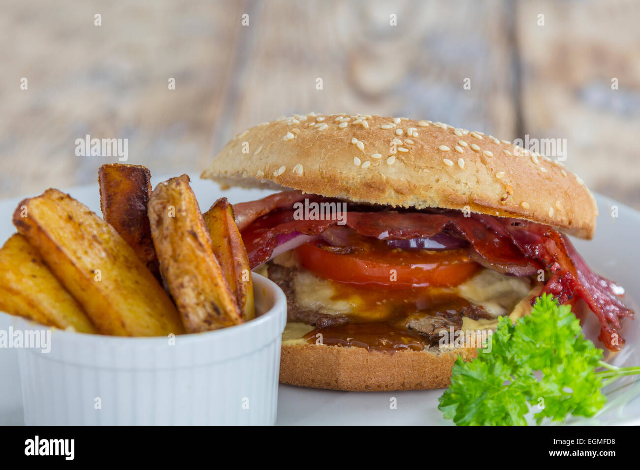 Homemade Hamburger and fries on a rustic wooden table Stock Photo - Alamy