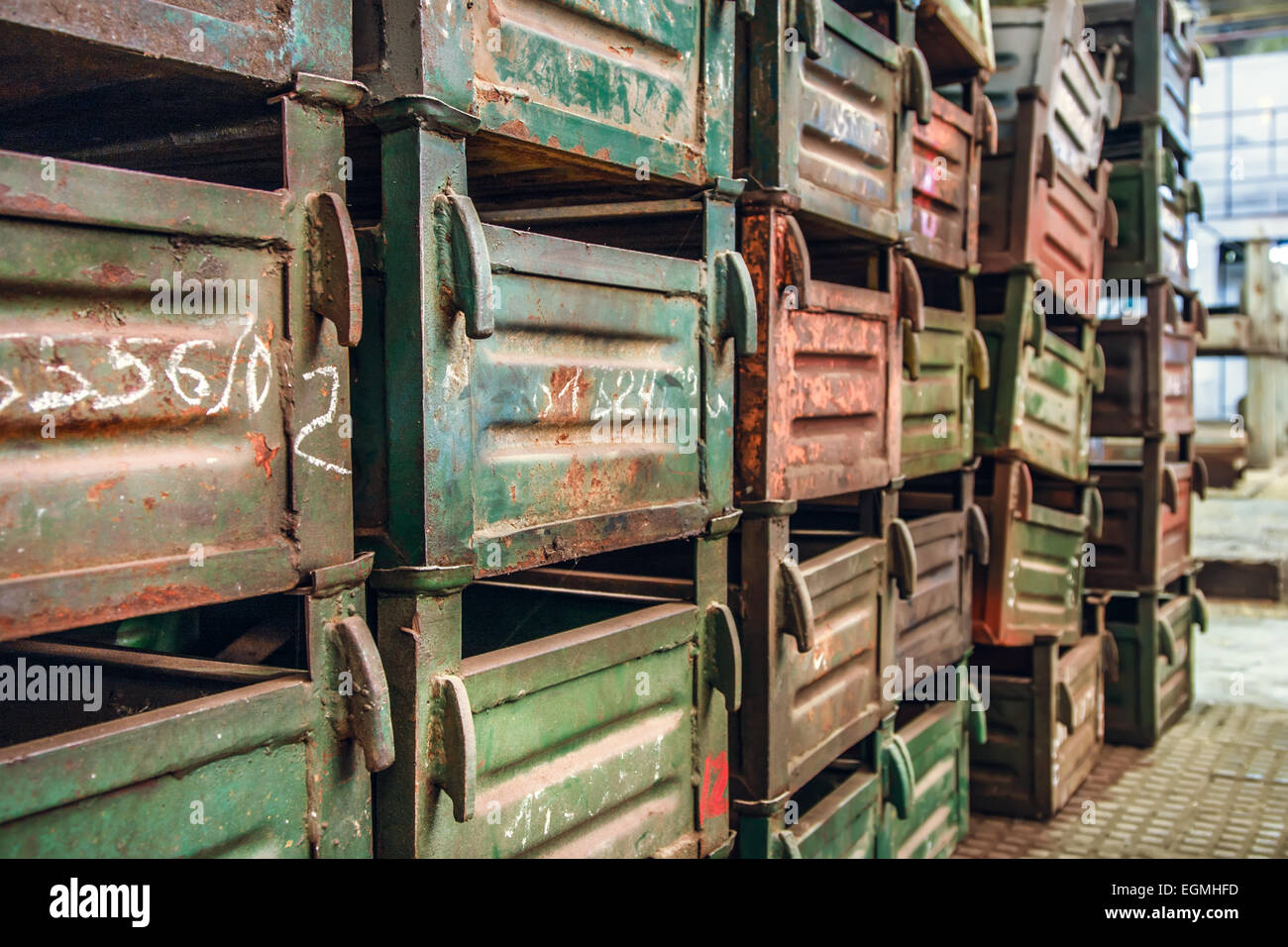 Old metal boxes stacked in storehouse of factory Stock Photo - Alamy
