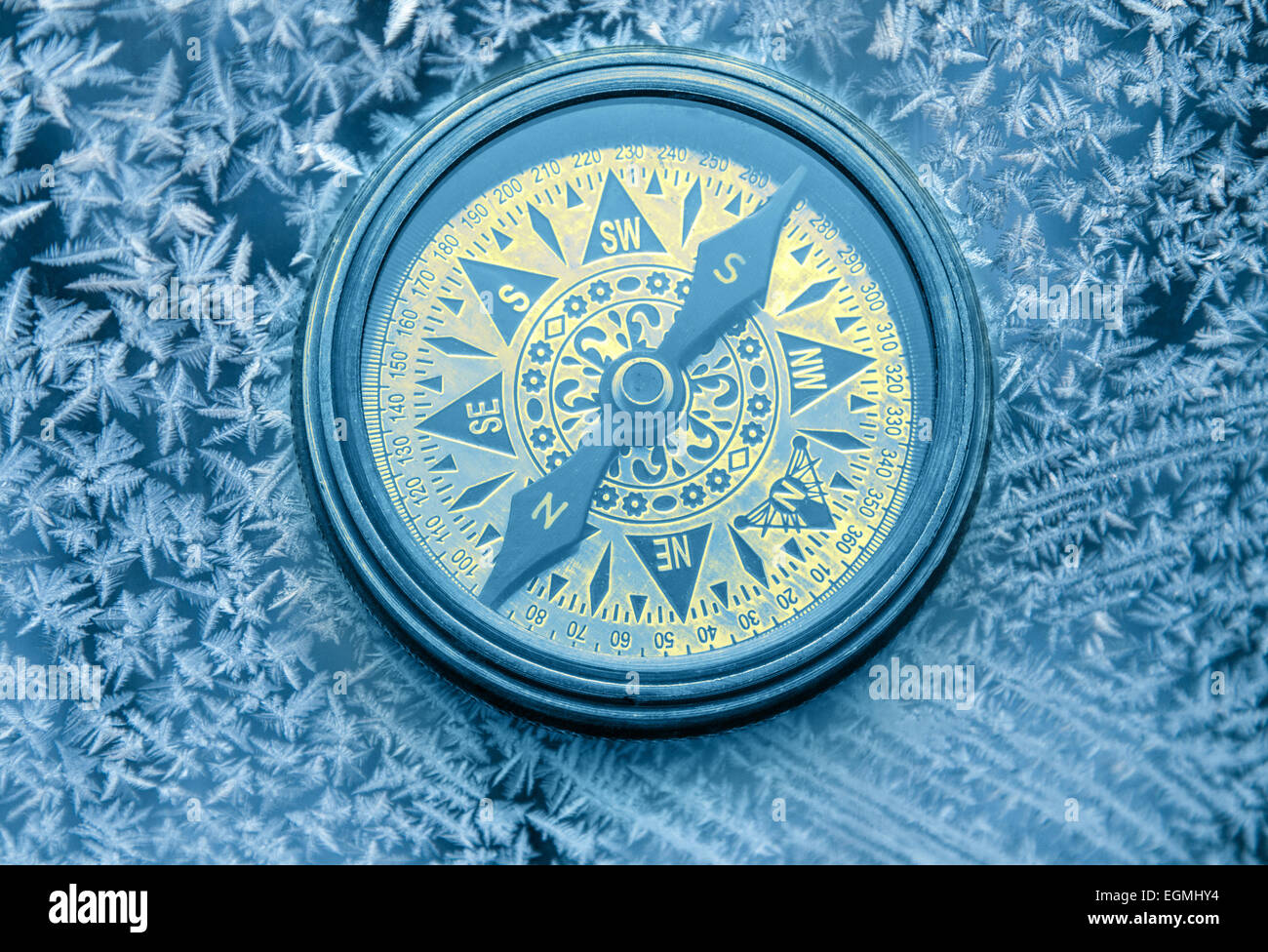 Vintage compass on snowflakes in blue toning Stock Photo - Alamy