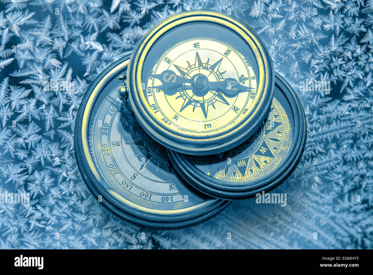 Vintage compass on snowflakes in blue toning Stock Photo - Alamy