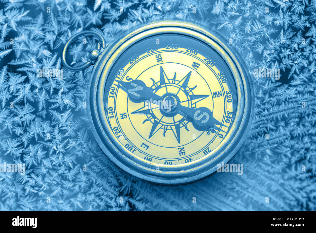 Vintage compass on snowflakes in blue toning Stock Photo - Alamy