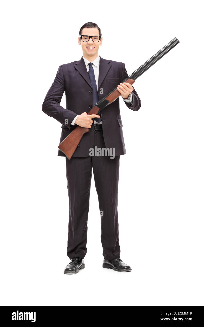 Full length portrait of a male bodyguard holding a shotgun isolated on ...