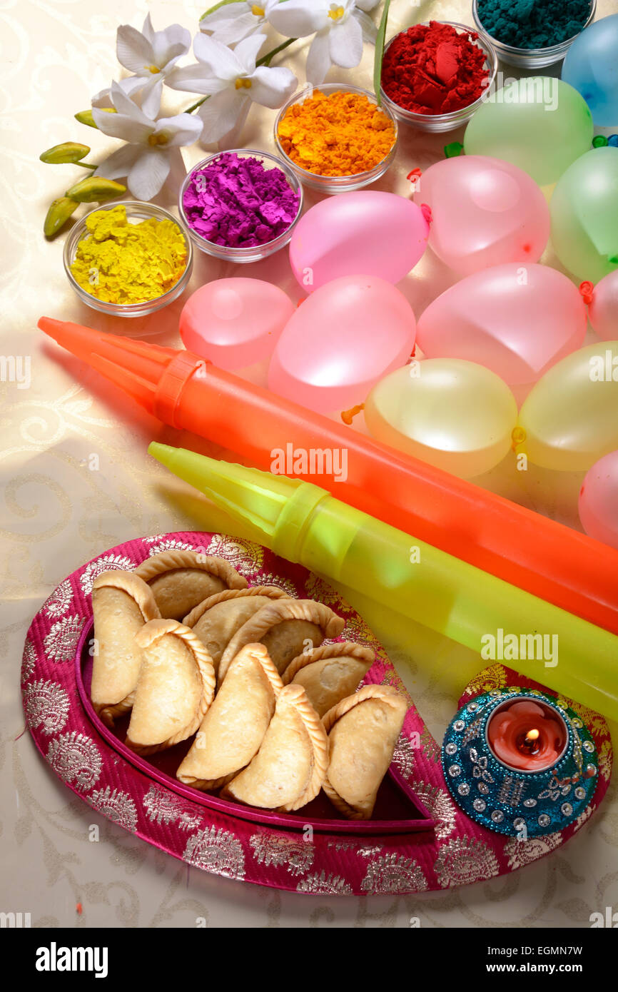 Colorful gulaal in the bowl, balloons, waterguns & gujia Stock Photo ...