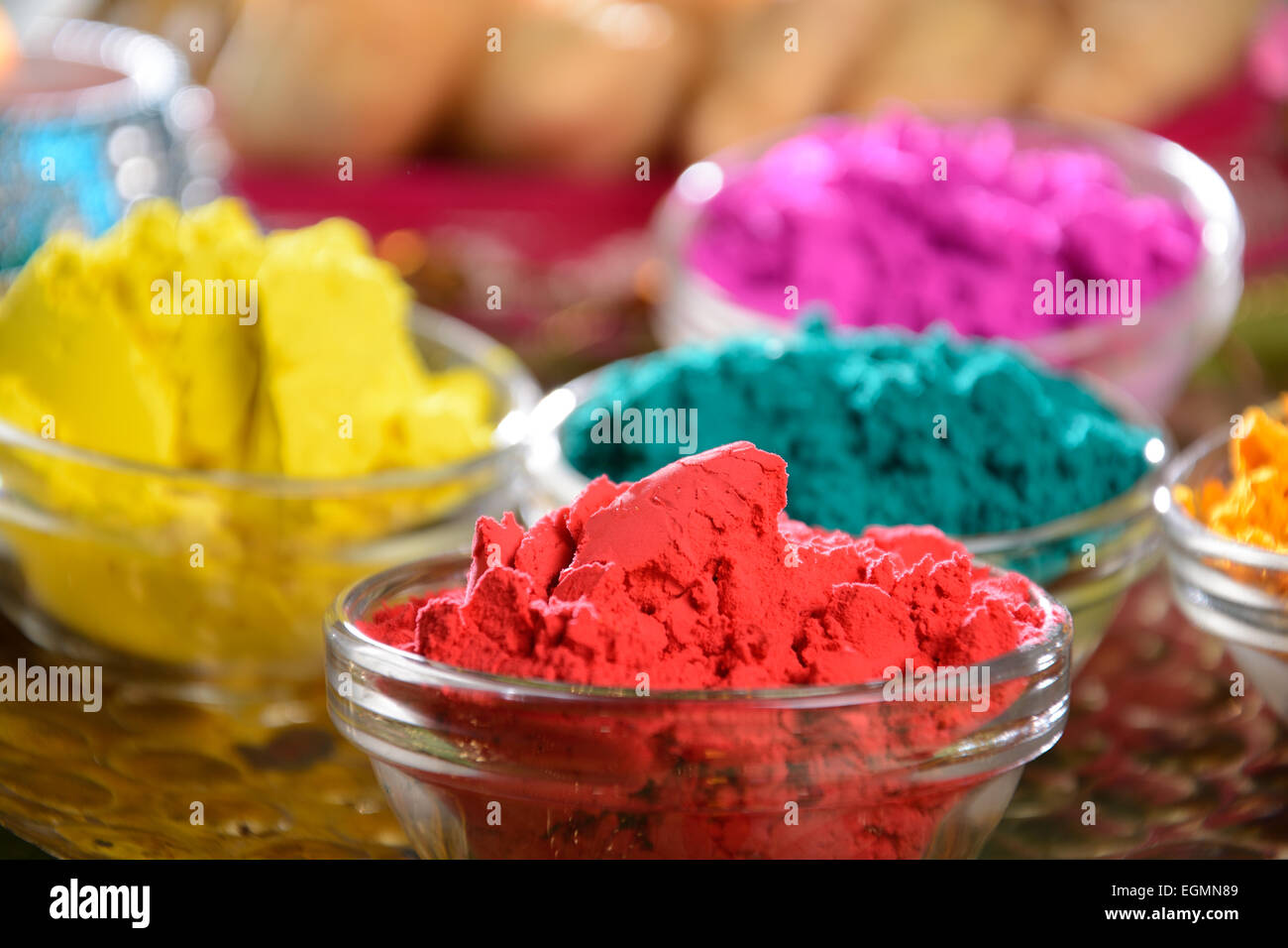 Gujia is a cuisine of India surrounded by colorful gulaal in the bowls ...