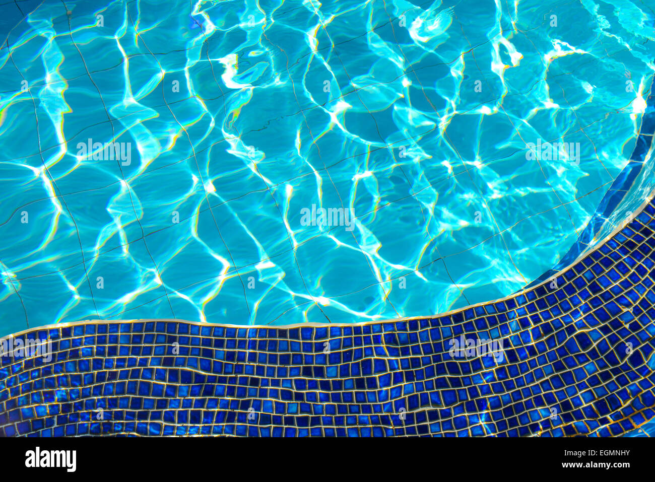 Blue tiles of jacuzzi in the Swimming pool blue water and sunlight ...