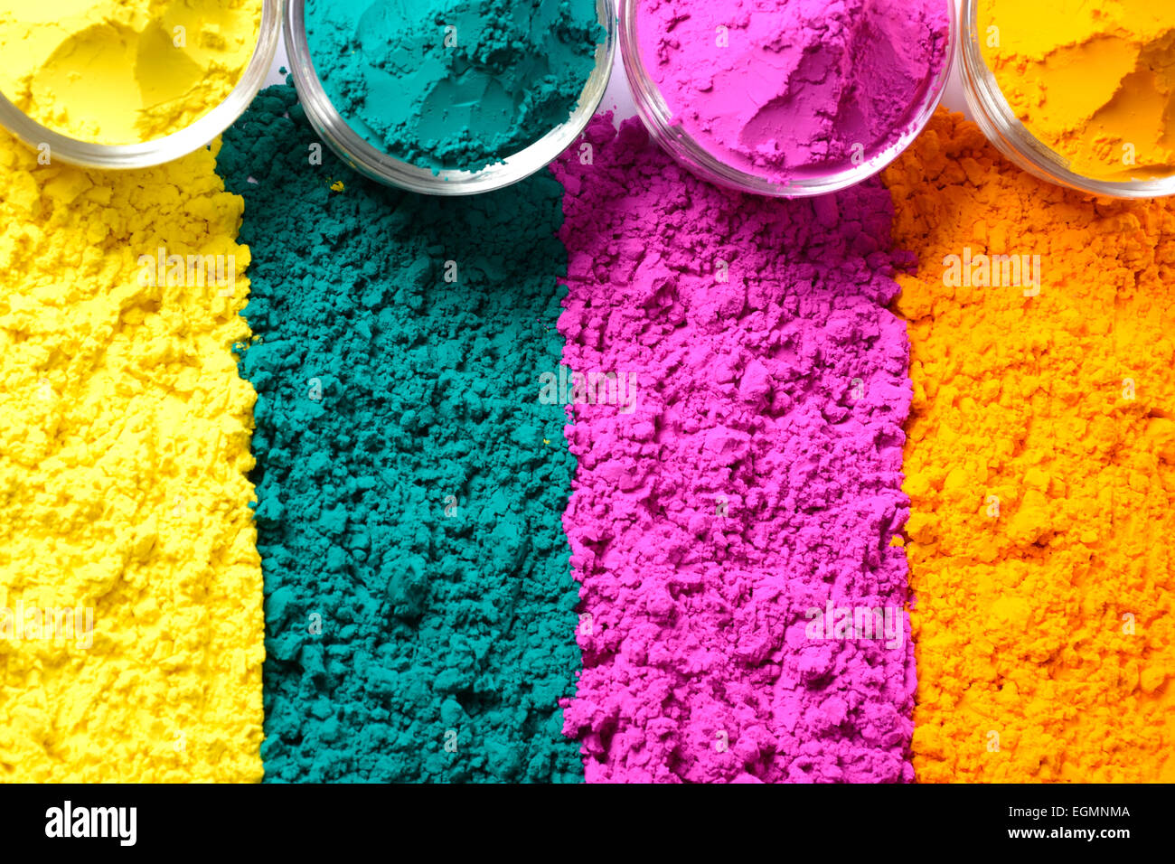 Heap of colorful gulaal in the bowls are leading to colorful strip of ...