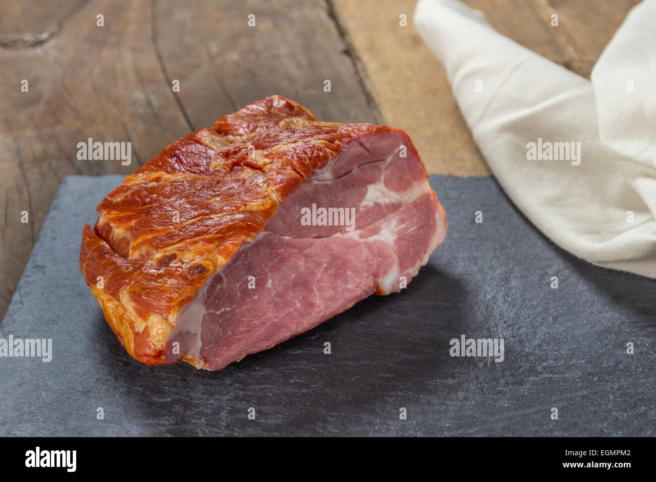 smoked pork chop on a rustic wooden table Stock Photo - Alamy
