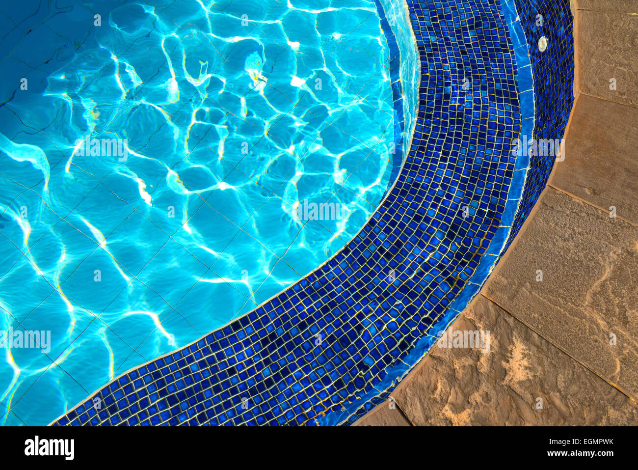 Blue tiles of jacuzzi in the Swimming pool blue water and sunlight ...