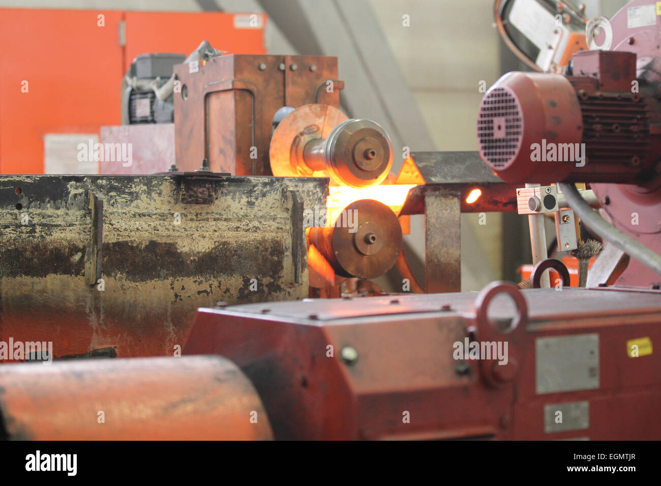 moving the heated metal rod through the rollers in rolling mill Stock ...