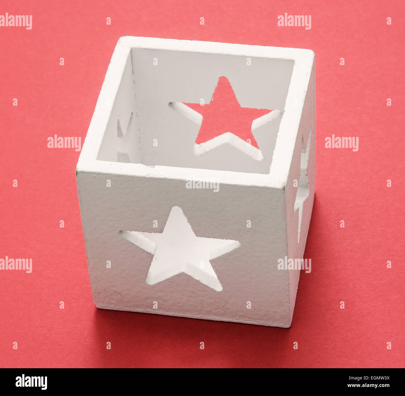 Decorative tea light holder with stars on the red background Stock ...