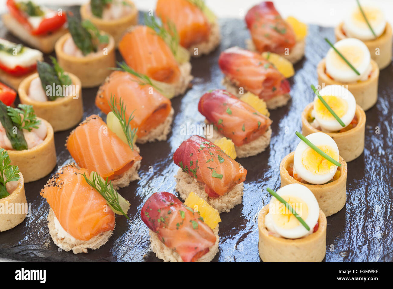 Canapes served on a slate 'plate' Stock Photo - Alamy