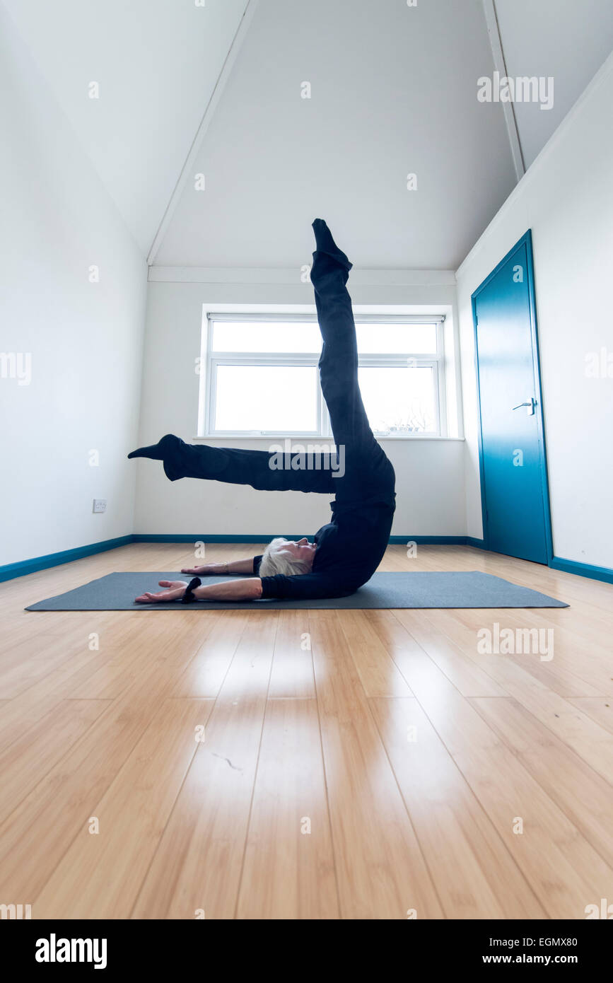 elderly older lady practicing palates yoga and keeping active while ...