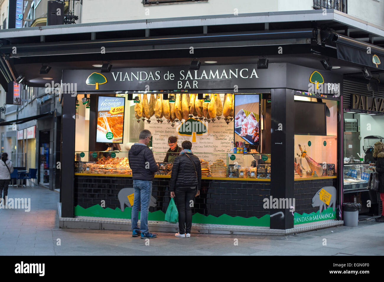 meat jamon ham iberico stall hams hanging street Stock Photo - Alamy
