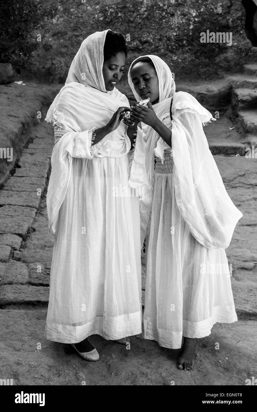 Two Female Pilgrims Dressed In The Traditional White Clothes look At ...