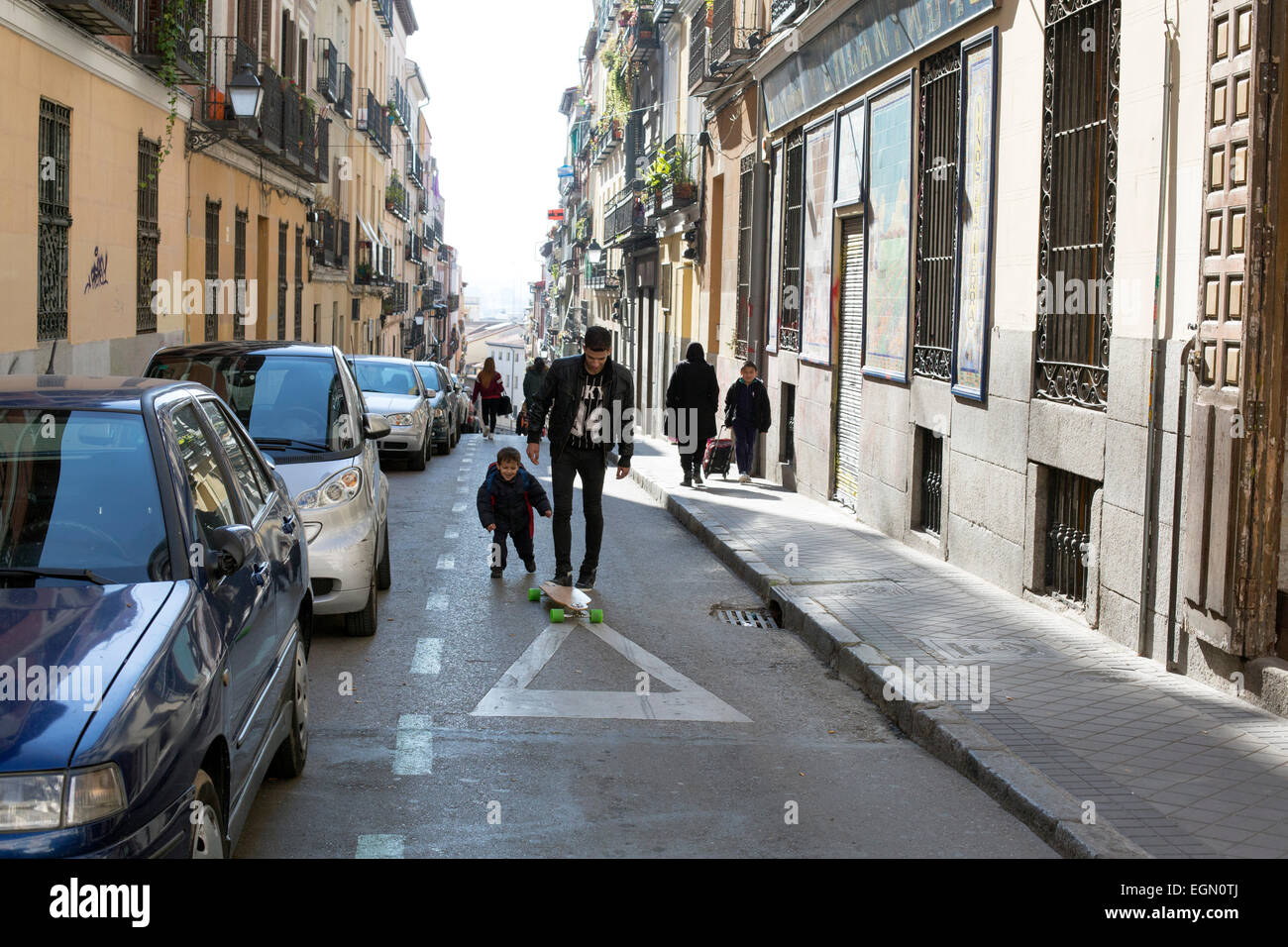 dad father skateboard kid son walking street play Stock Photo - Alamy