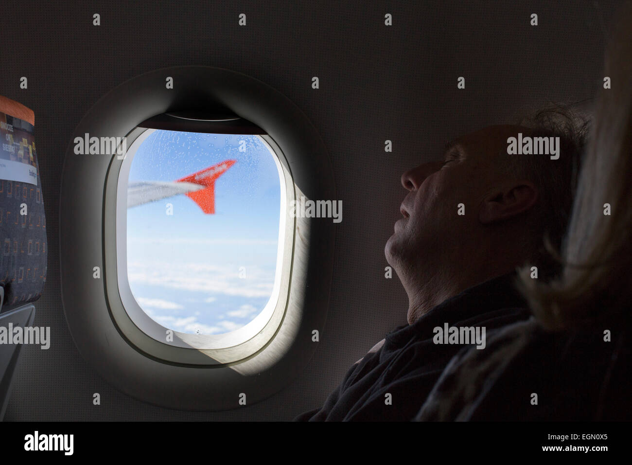 plane aeroplane window porthole wing mountains flight Stock Photo - Alamy