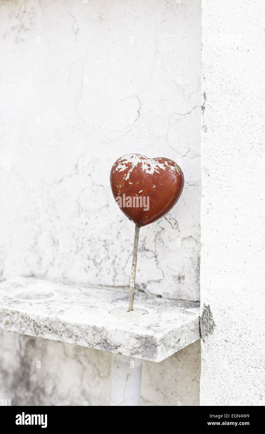 Red heart on marble, detail of a decorative heart on a marble tomb ...