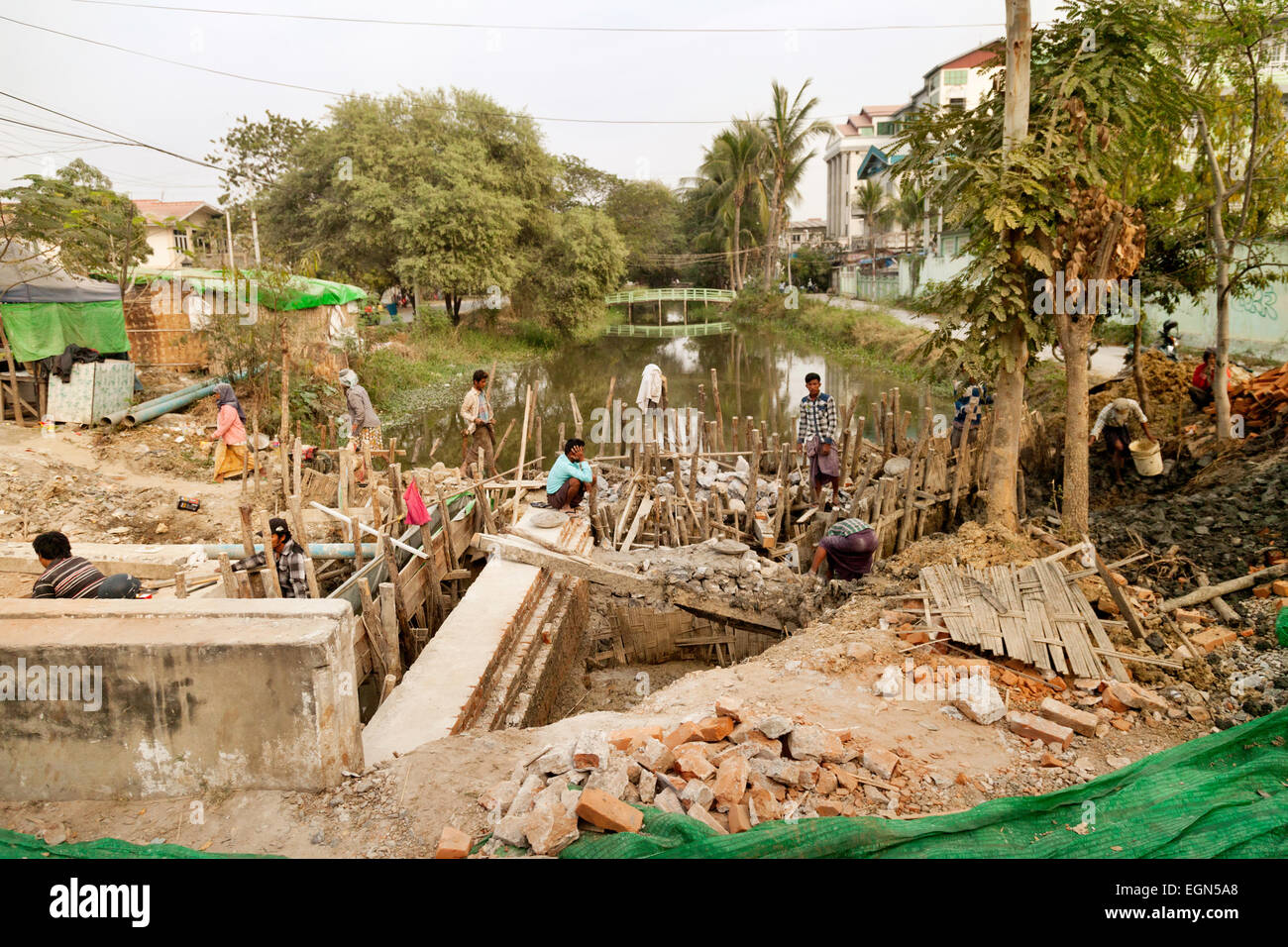 Construction workers building by the side of the road, Mandalay ...
